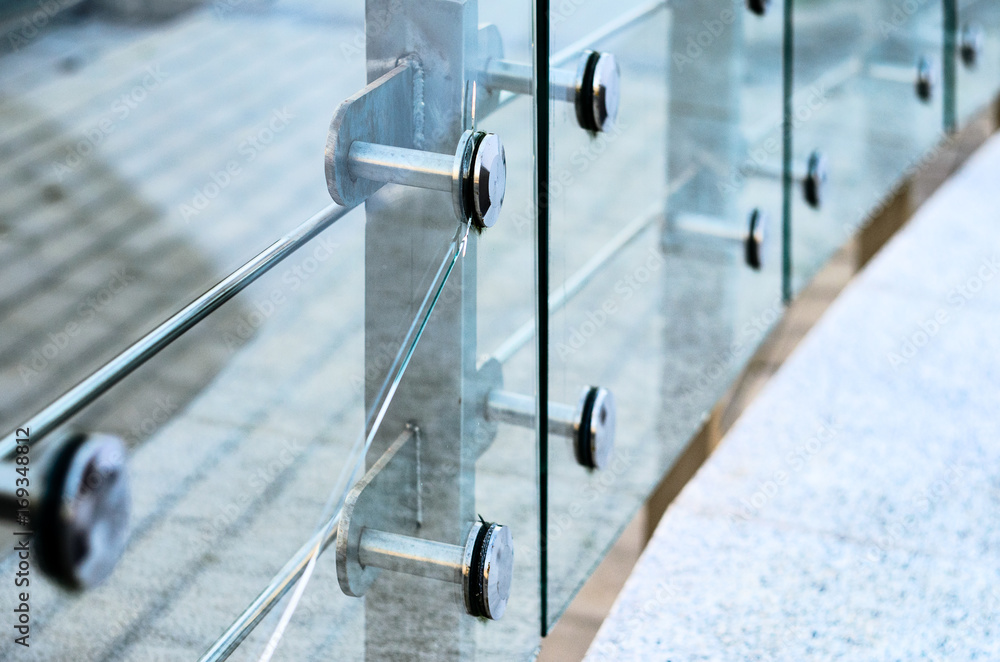Closeup Modern glass fence with broken glass panel at the junction of ...