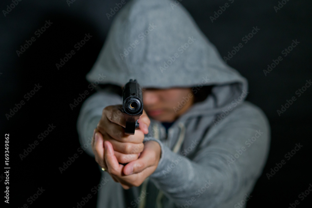 woman pointing gun at the target / selective focus / killer / safety ...