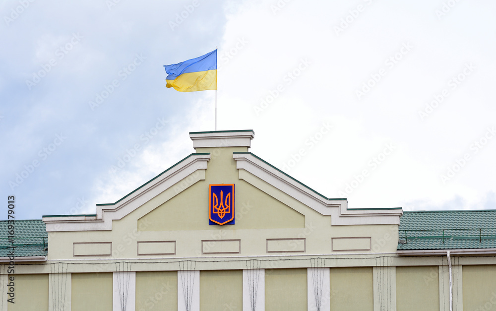 Ukrainian flag on the flagpole flies against a sky. Ukrainian flag on ...