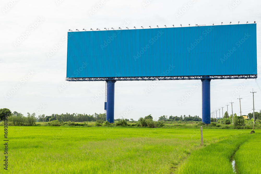 Large white advertising billboard in green rice field. for design and ...