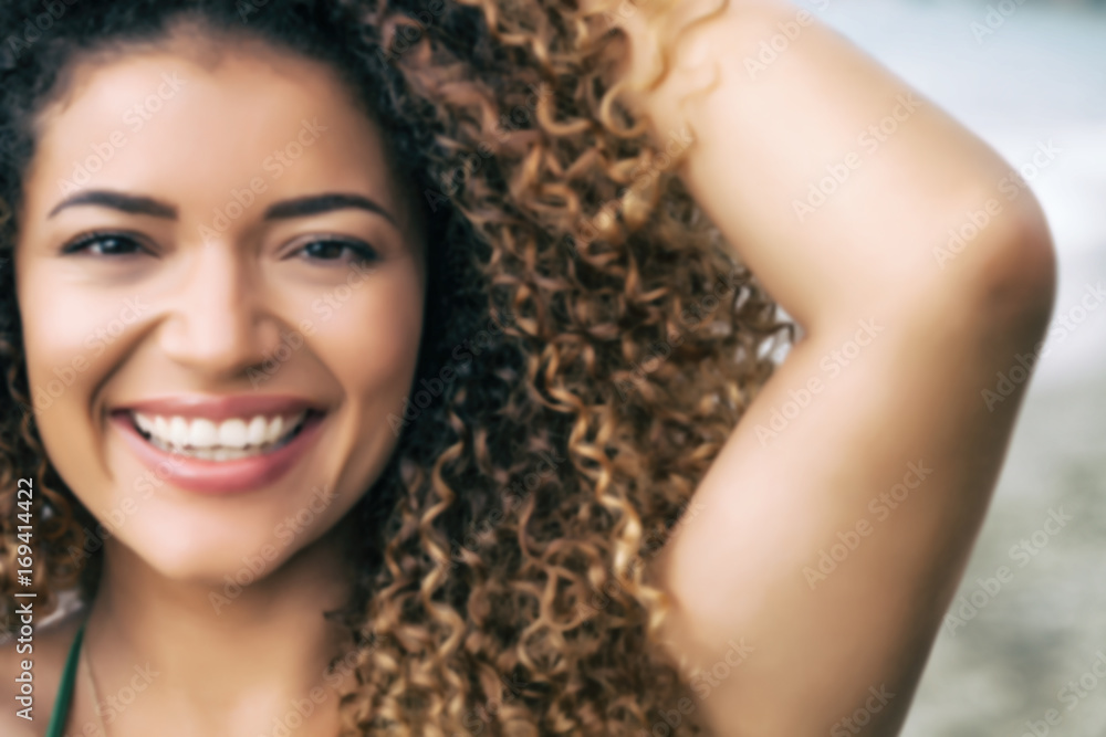 Out of focus portrait of young, lovely woman smiling and looking at ...