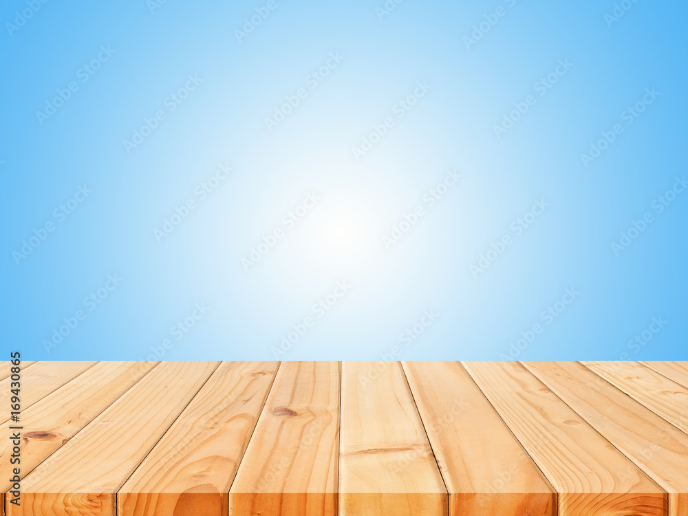 Natural wood table texture with deep blue gradient wall background ...