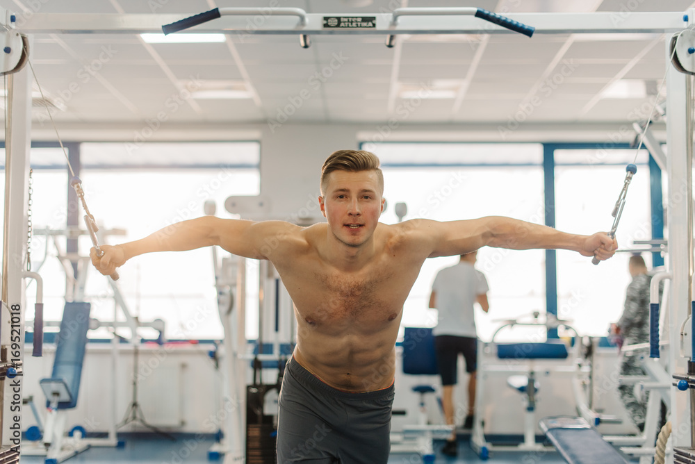 Strongman training on Fitness-station. Man with six-pack abs. He ...