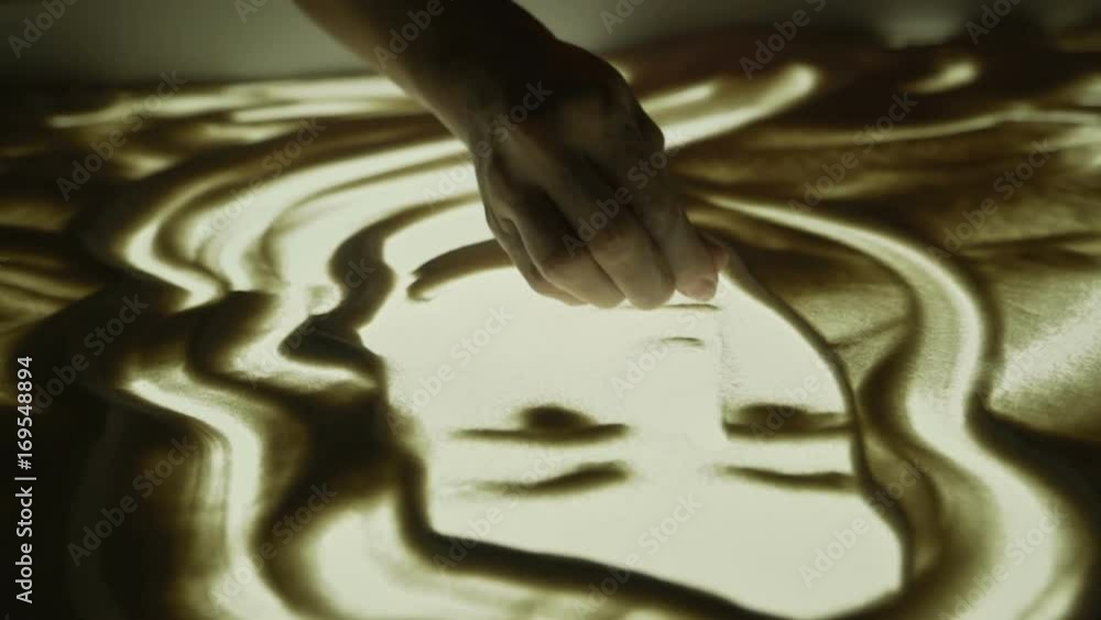 Drawing with sand. Short show. Drawing sand on a white screen. Sand ...