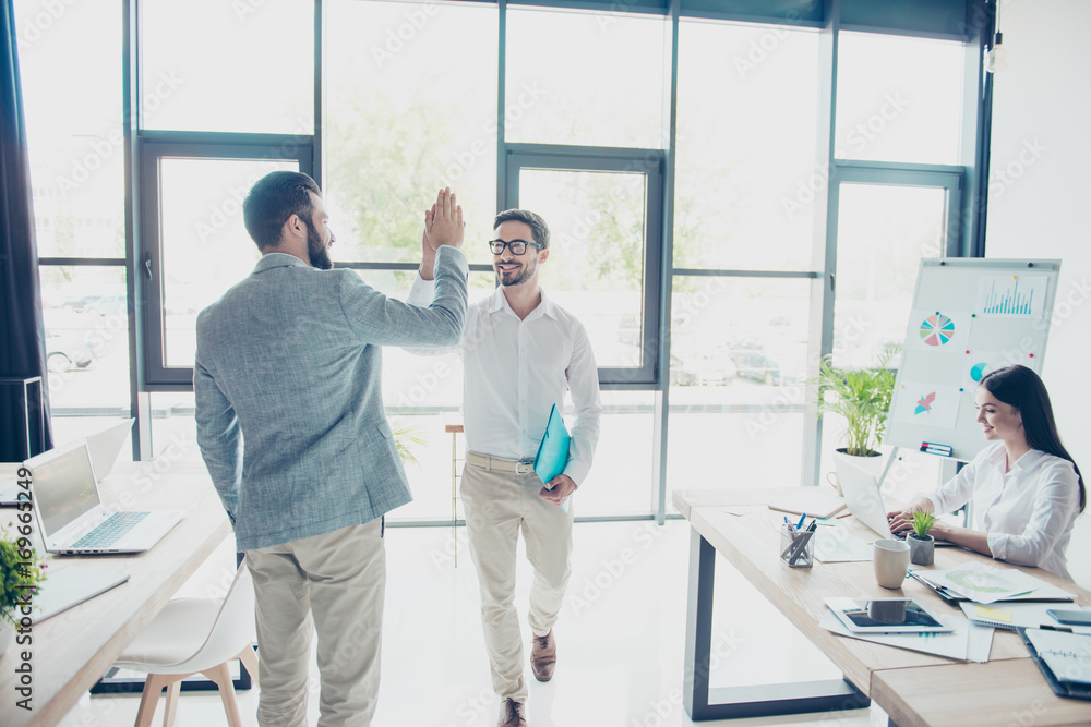 Team work concept. Two friendly handsome brunet guys colleagues ...