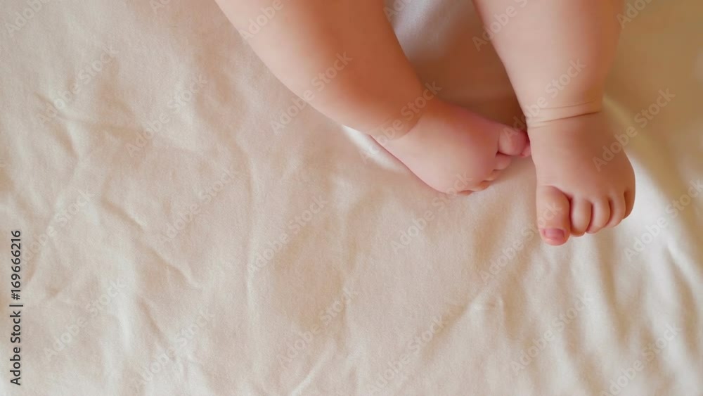 Two little feet a newborn baby On a white background. Full HD 1080p ...