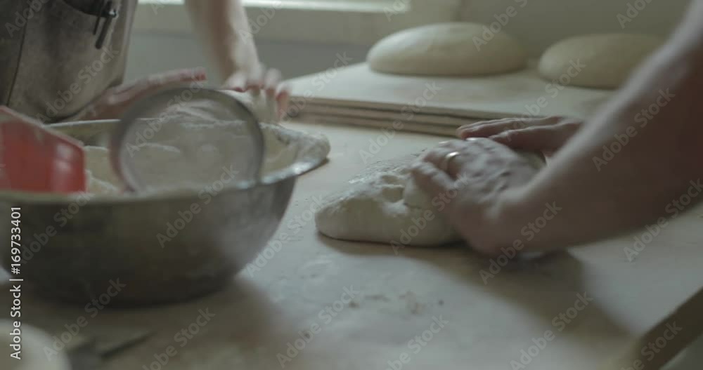 Bakers make bread by kneading bread dough to bake loaves of healthy ...