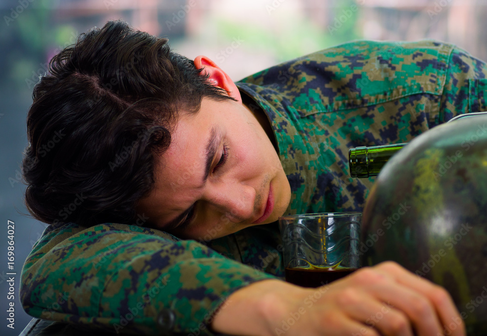 Handsome sleep young soldier wearing uniform suffering from stress post ...