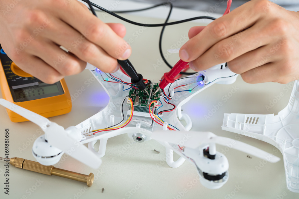 Man Testing Electric Current Of Drone Using Multimeter Tool Stock Photo ...
