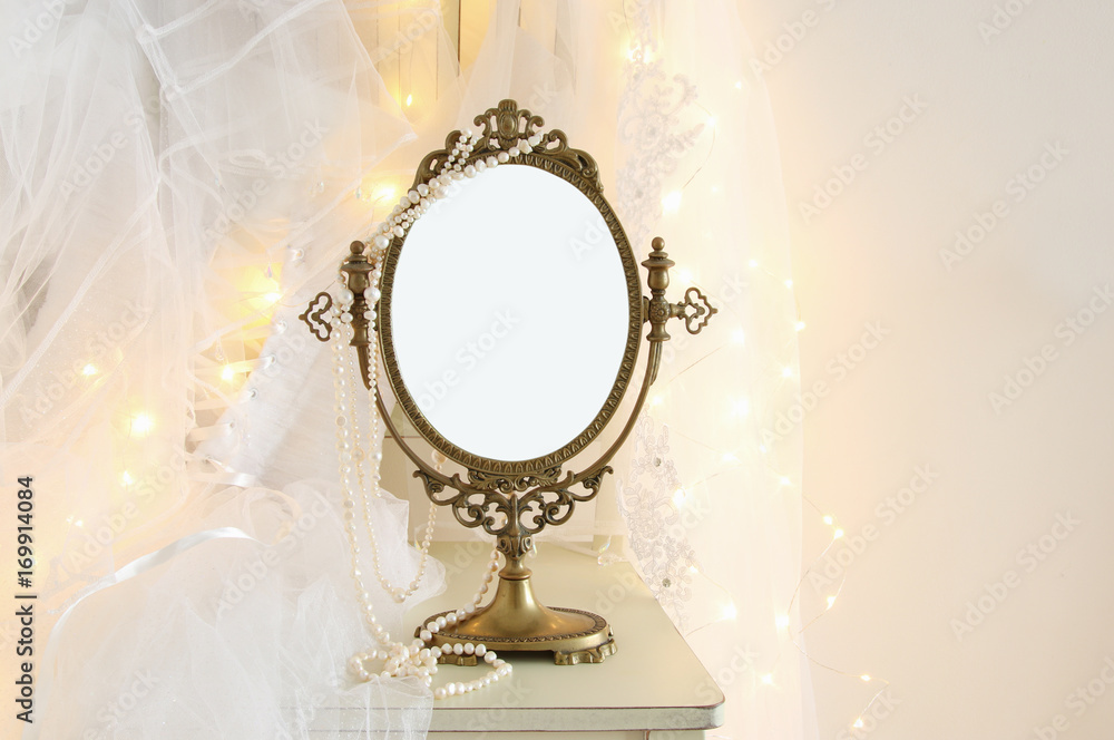 Old vintage oval mirror and beautiful white wedding dress and veil on ...