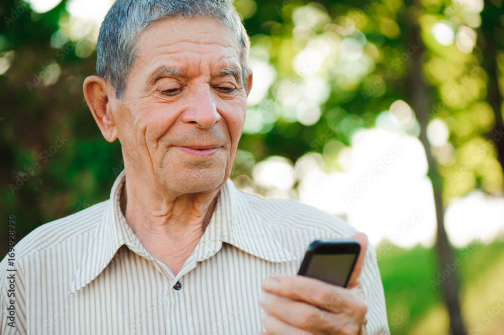 Grandfather with mobile phone in hand Stock Photo | Adobe Stock