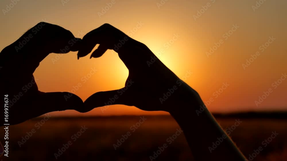hands forming a heart shape with sunset silhouette. hands-shape for the ...