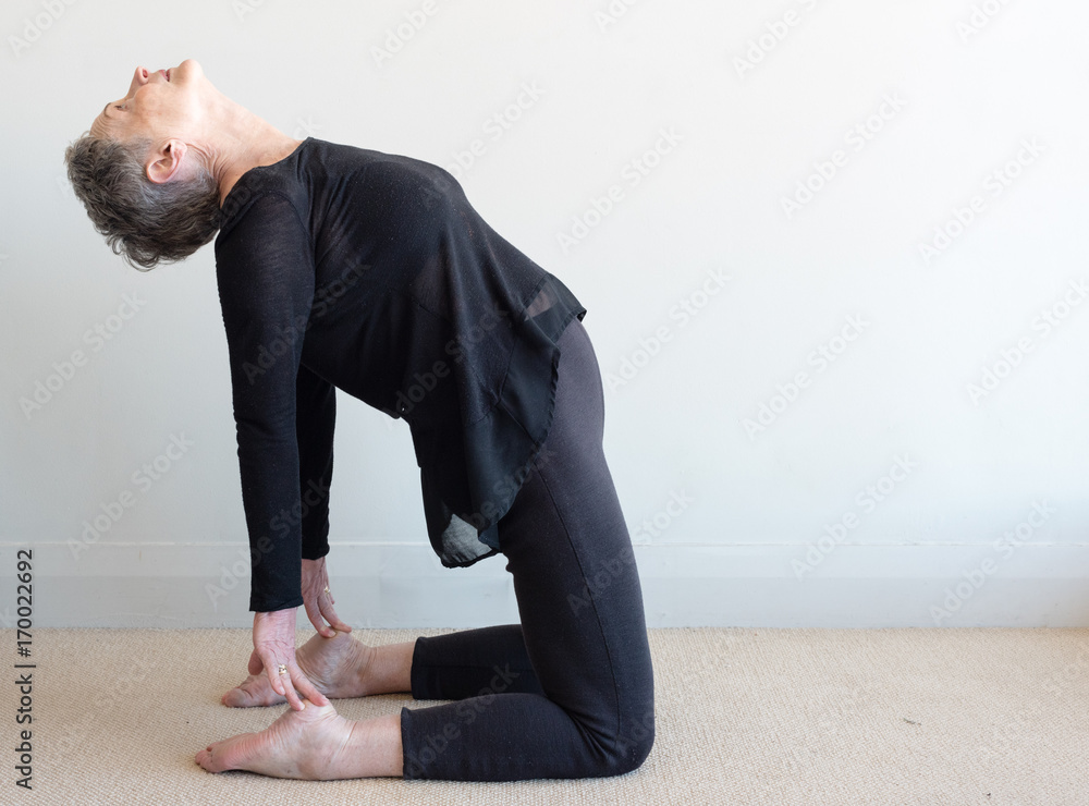 Side view of older woman with short grey hair and black clothing in ...