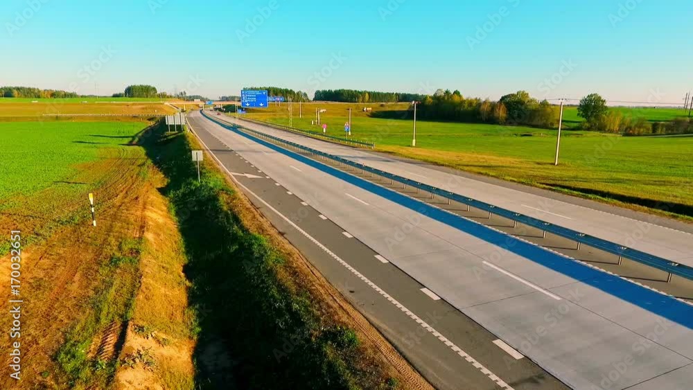 Cars and cargo trucks driving on highway road. Highway sing on country ...