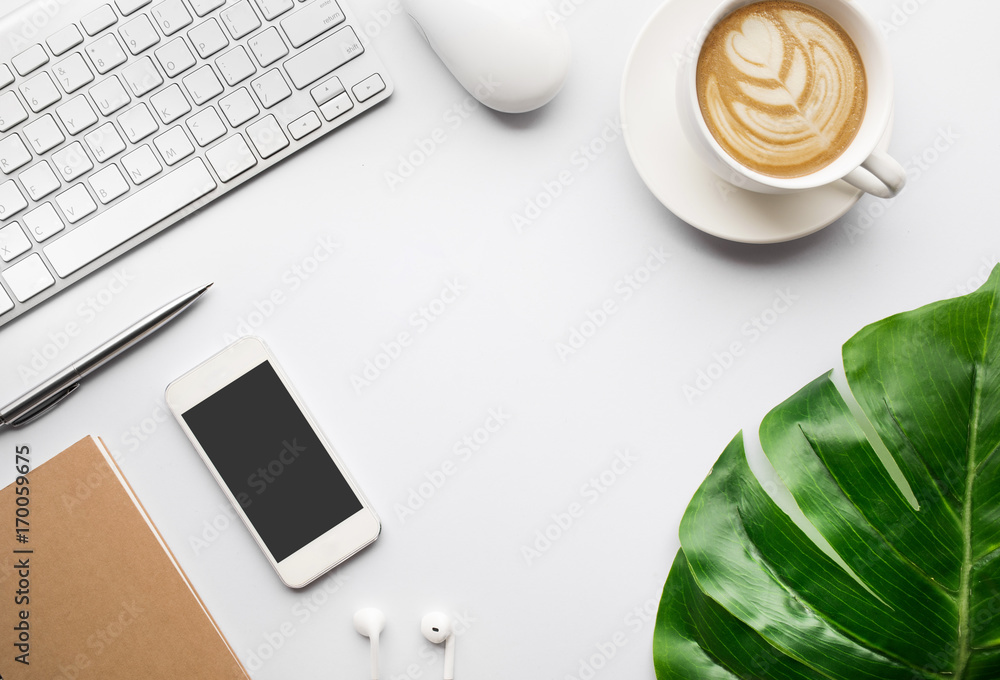 Top view modern office desk table with tropical leaves and supplies in ...