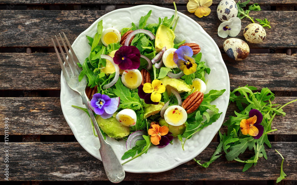 Healthy summer salad with quail eggs, avocado, pecans, wild rocket, red ...
