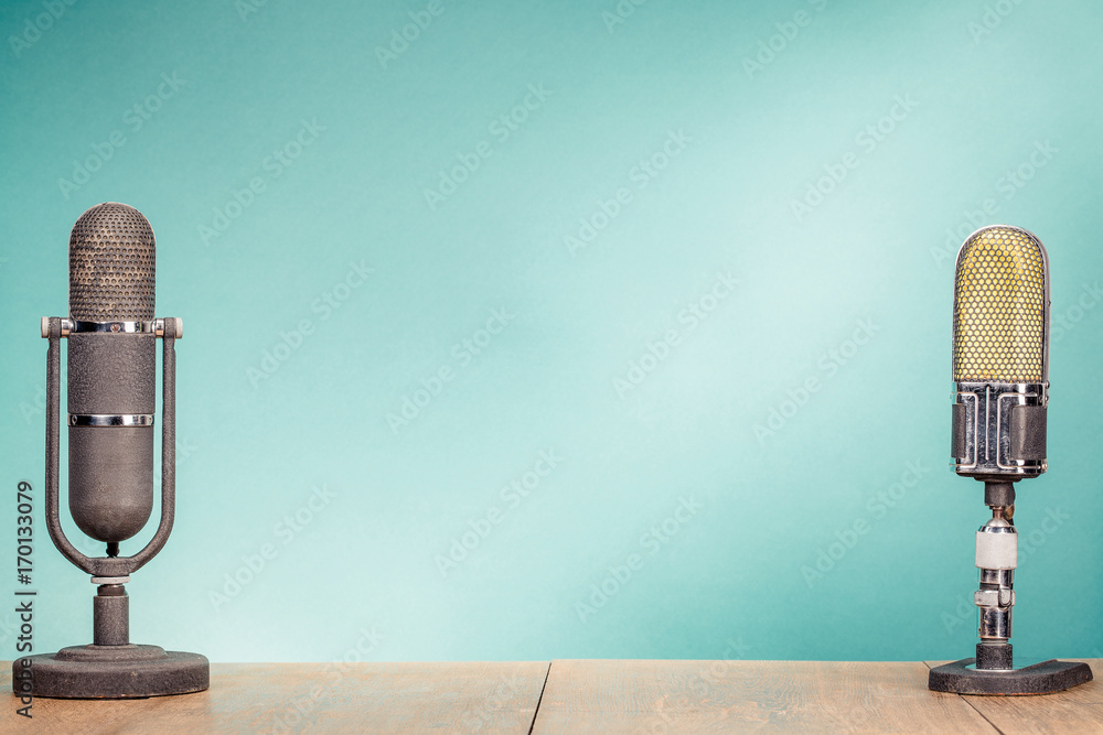 Old retro big microphones from 50s on table front gradient mint green ...