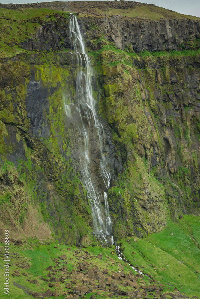 Huge waterfall off the side of a mountain in Iceland Stock Photo ...