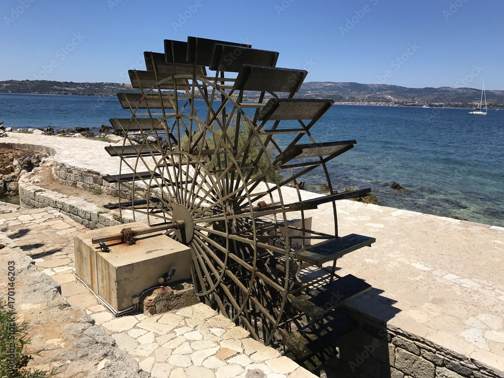 An ancient water mill turning in Katavothres, sinkholes where seawater ...