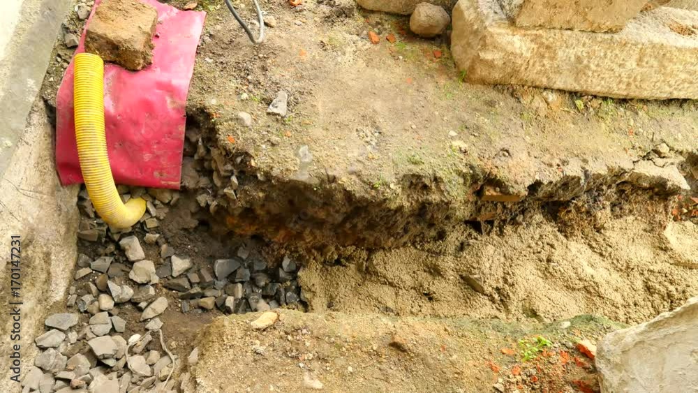 Pouring, laying concrete into foundations of the house using shovel of ...