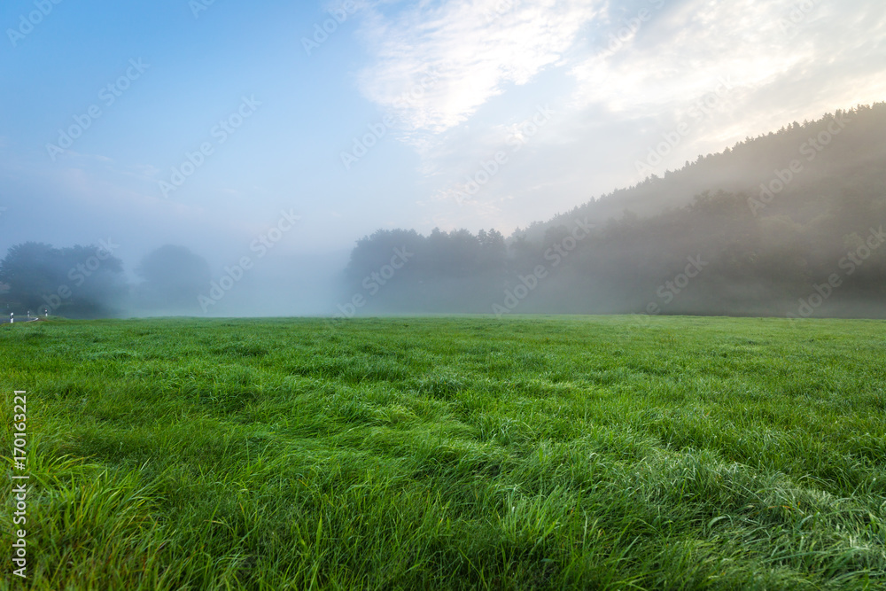 Blue sky with landscape in fog Stock Photo | Adobe Stock