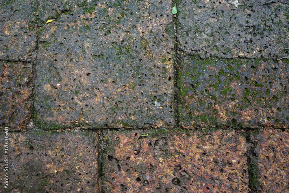 Humid rusty red brick stone laterite pavement block pattern background ...