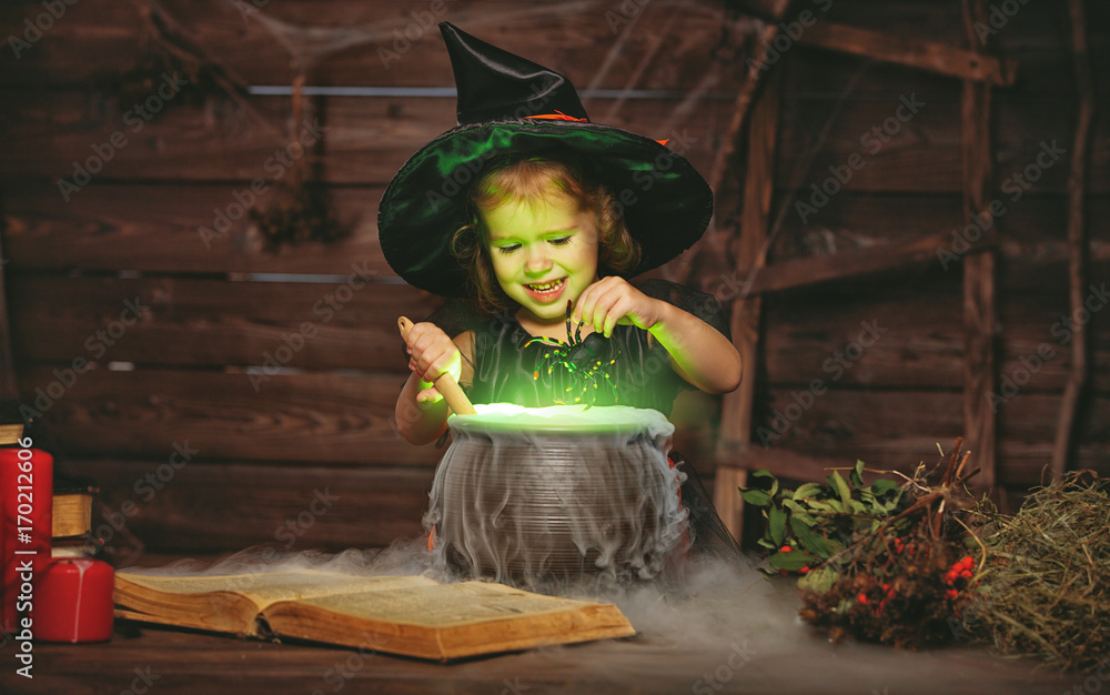 Halloween. little witch child cooking potion in cauldron with spell ...