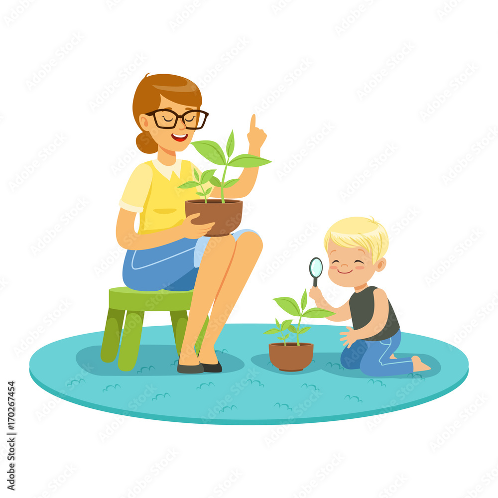 Little boy examining a plant through a magnifying glass and learning ...