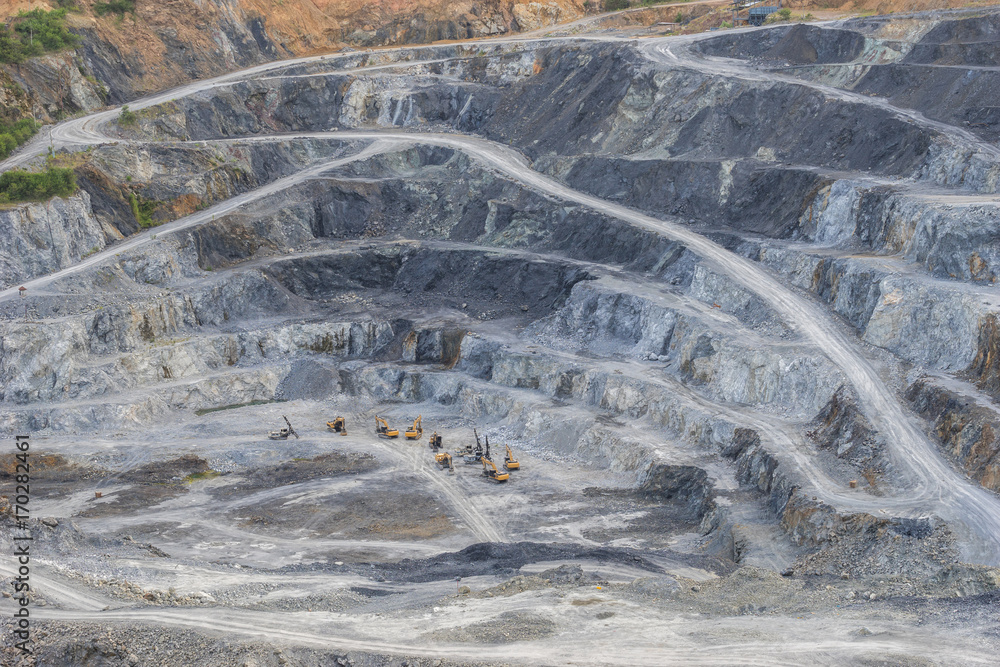 The tracked excavators are parked in the stone quarry after work. Stock ...