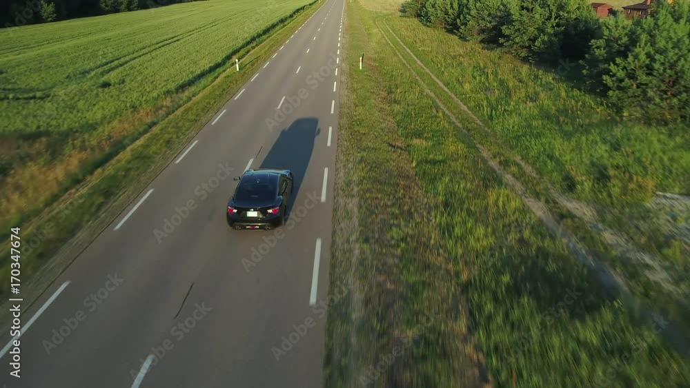 aerial view of sport car driving in fields Stock Video | Adobe Stock