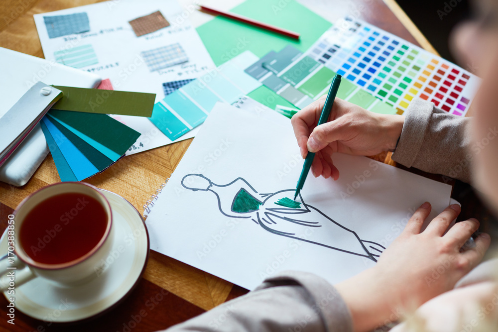 Over shoulder view of unrecognizable fashion designer drawing sketch ...