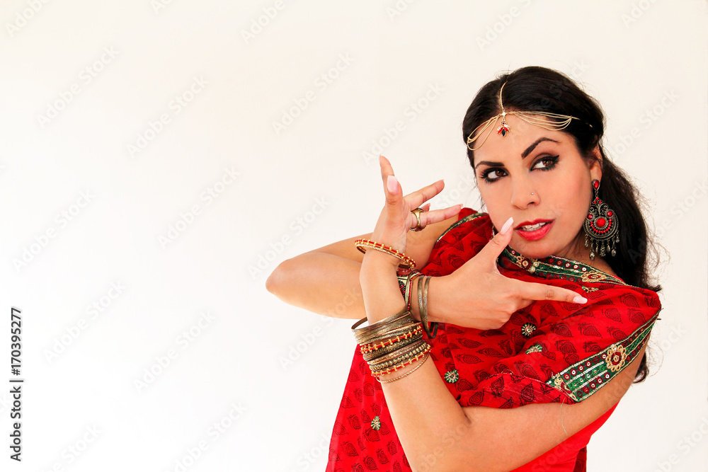 Woman dancing Indian dance in national dress. A handsome beautiful girl ...
