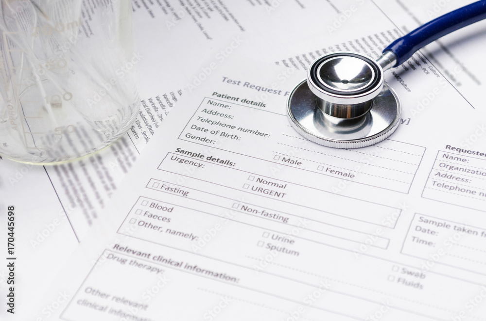 close up stethoscope, test tube, beaker and patient information form on ...