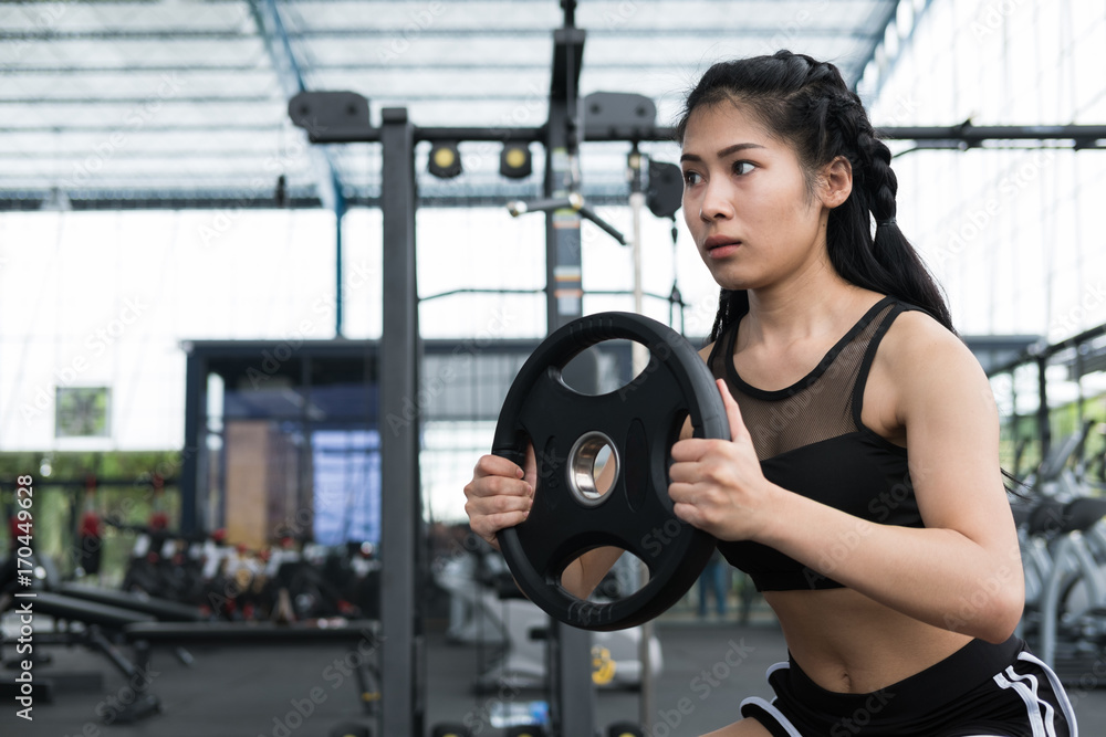 young woman bodybuilder execute exercise in fitness center. female ...