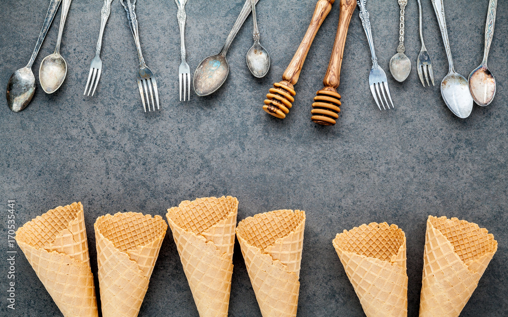 Flat lay ice cream cones collection , spoons ,fork and honey dipper on ...