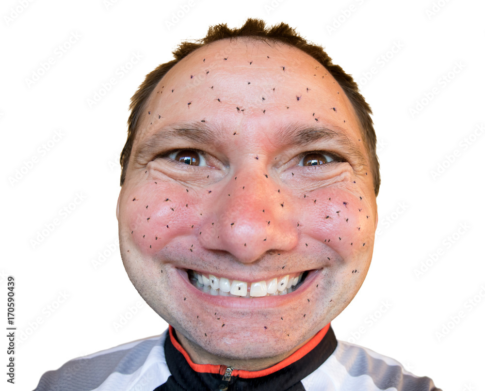 Funny portrait of sweaty biker with flies stuck to his face. Cheerful ...