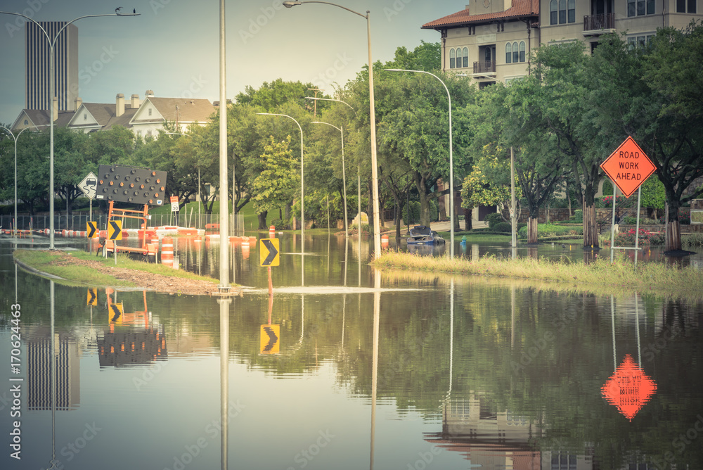 High water rising at Allen Parkway with road warning signs. Residential ...