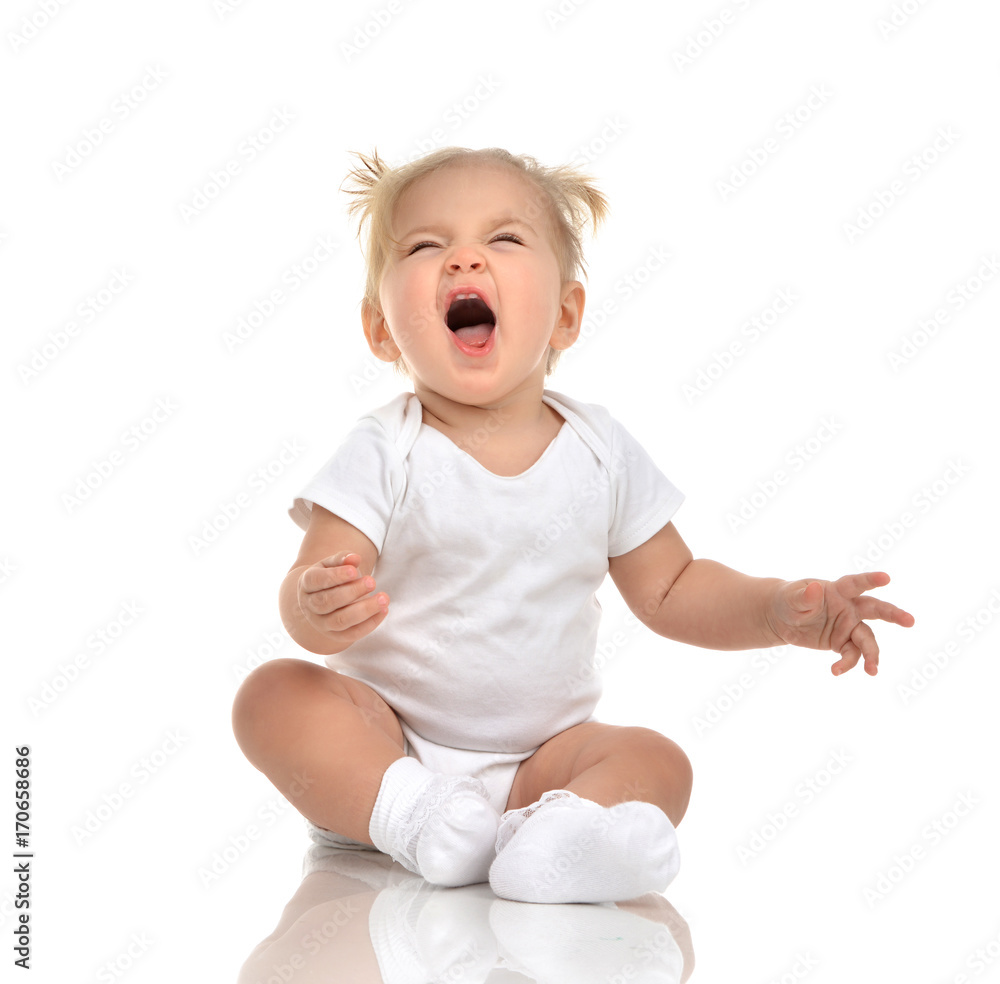 Small infant child baby girl toddler sitting and screaming yelling ...