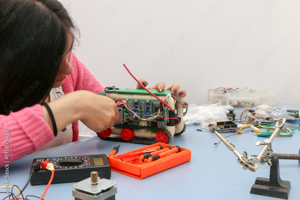 Young electronics student learning about basic PCB connection and ...