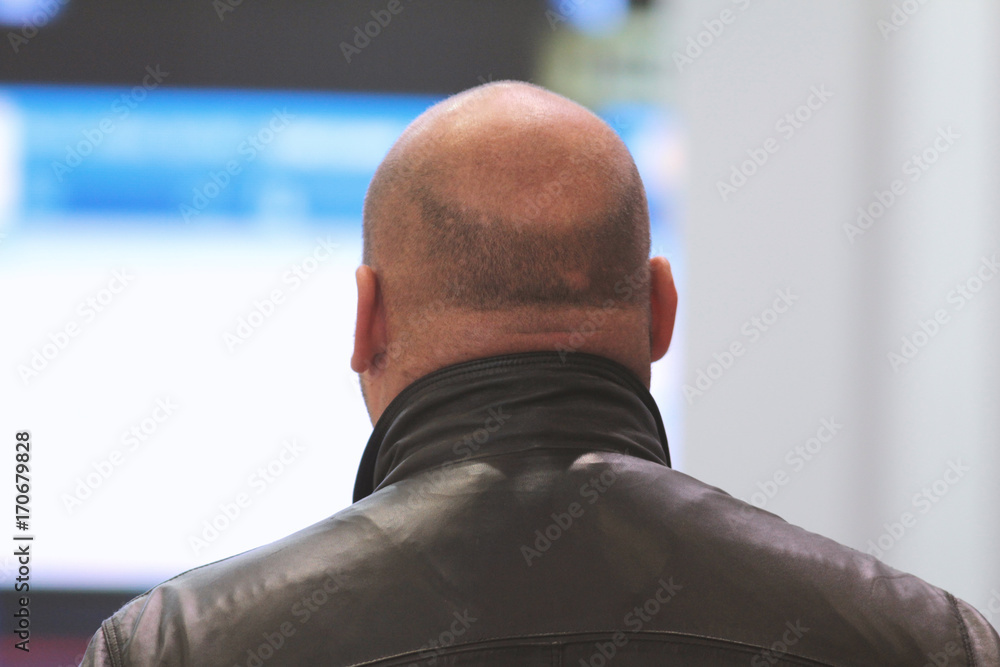 Big bald man in leather jacket at conference hall - rear view Stock ...