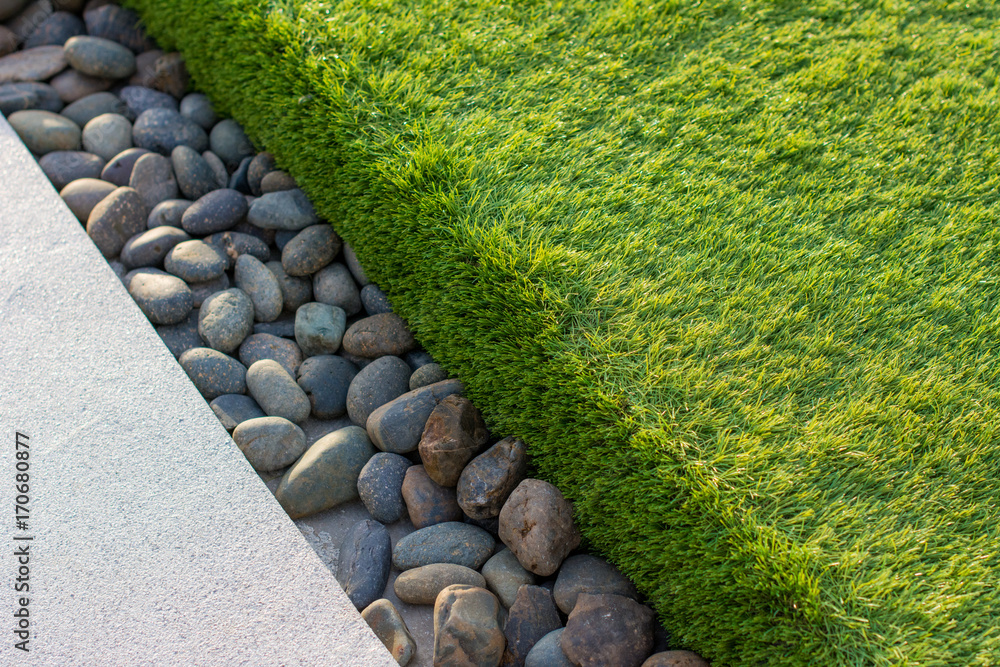 Part View Of Stone between green grass floor and foot path on the ...