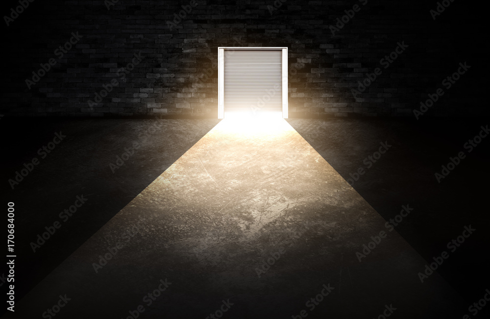 Opening roller shutter door and concrete floor outside factory building ...