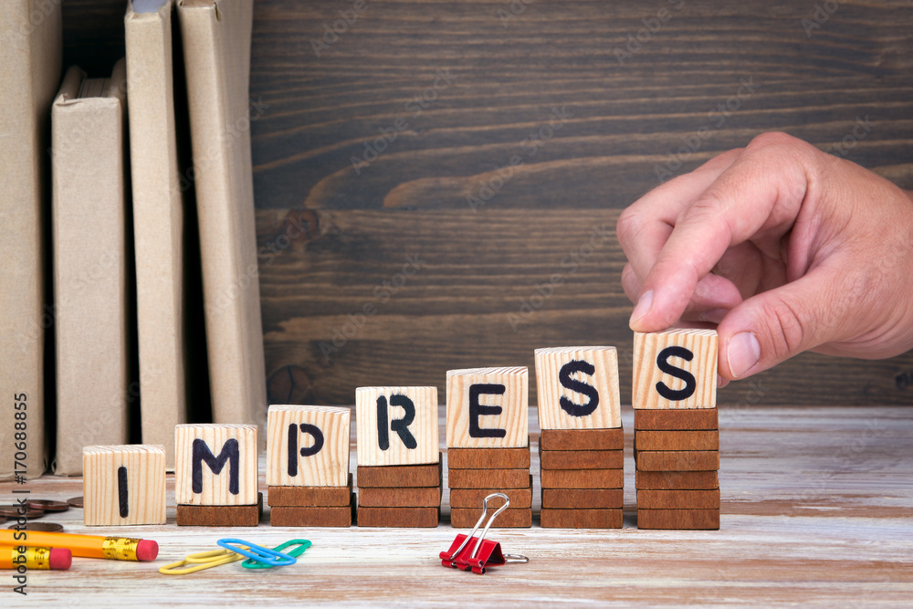 Impress concept. Wooden letters on the office desk, informative and ...