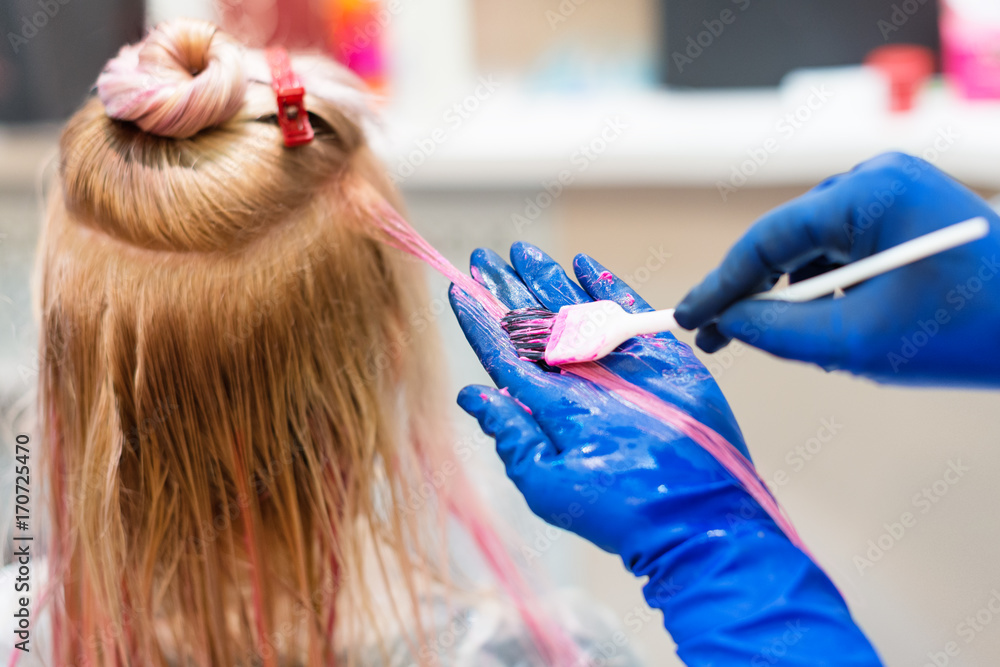 Hairdresser is dying female hair. Hands in glives with brush, coloring ...