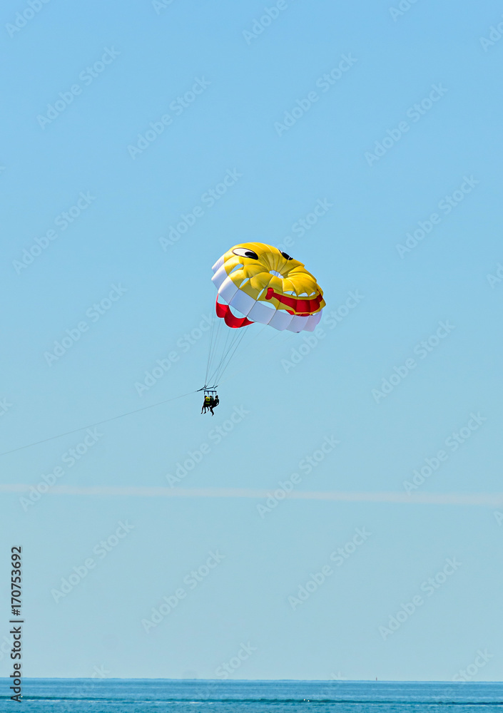 Colored parasail wing pulled by a boat in the sea water, Parasailing ...