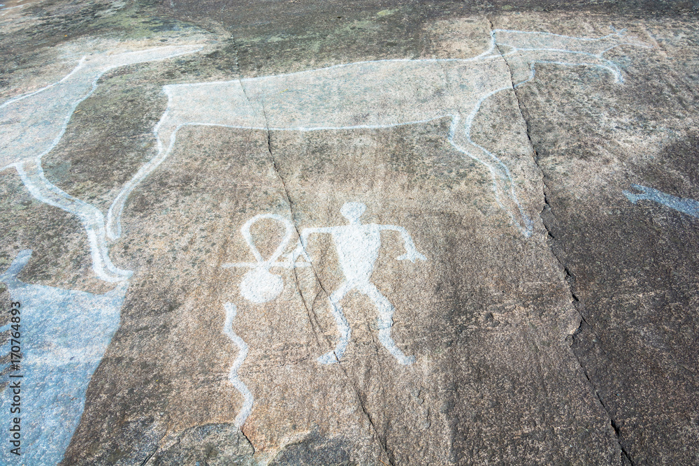Ancient drawings on a large rock. Stock Photo | Adobe Stock