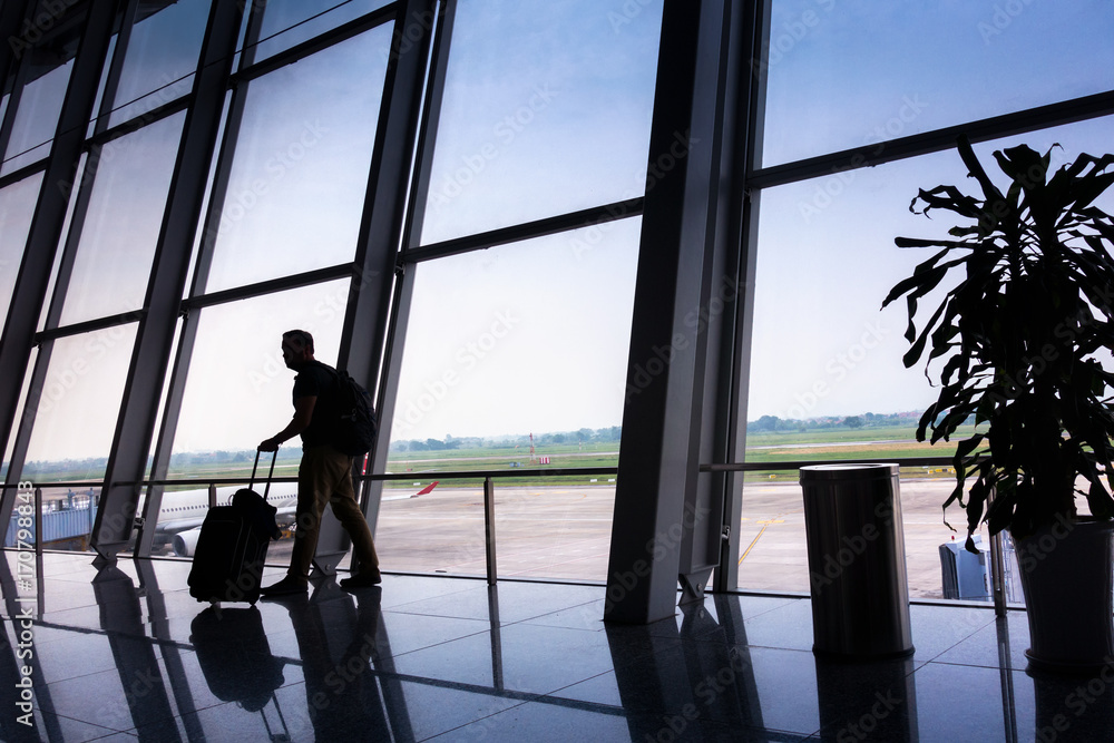 Passengers tourist standing with luggage and watching landing aircraft ...