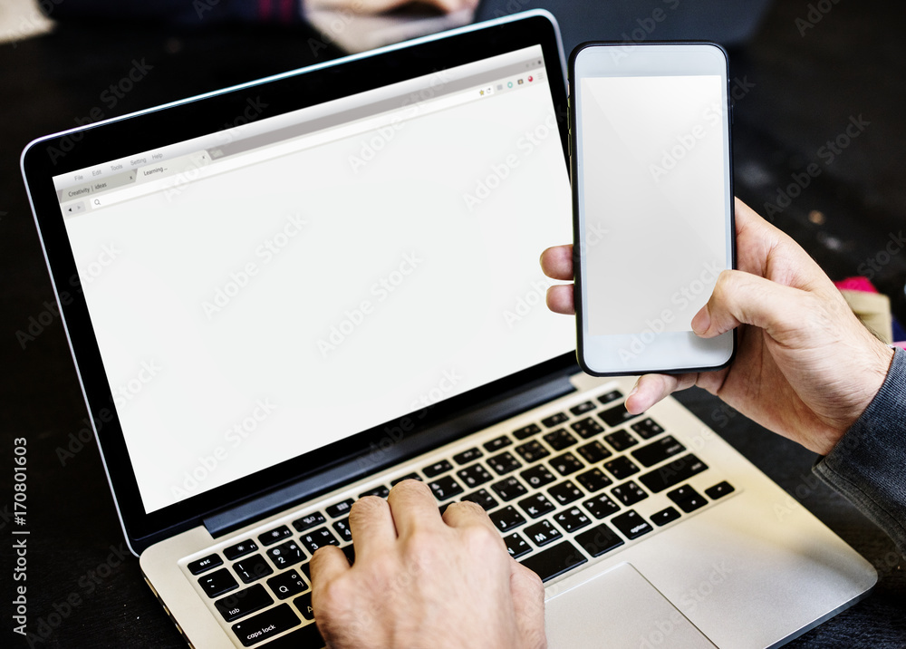 Hands holding mobile phone with computer laptop background Stock Photo ...