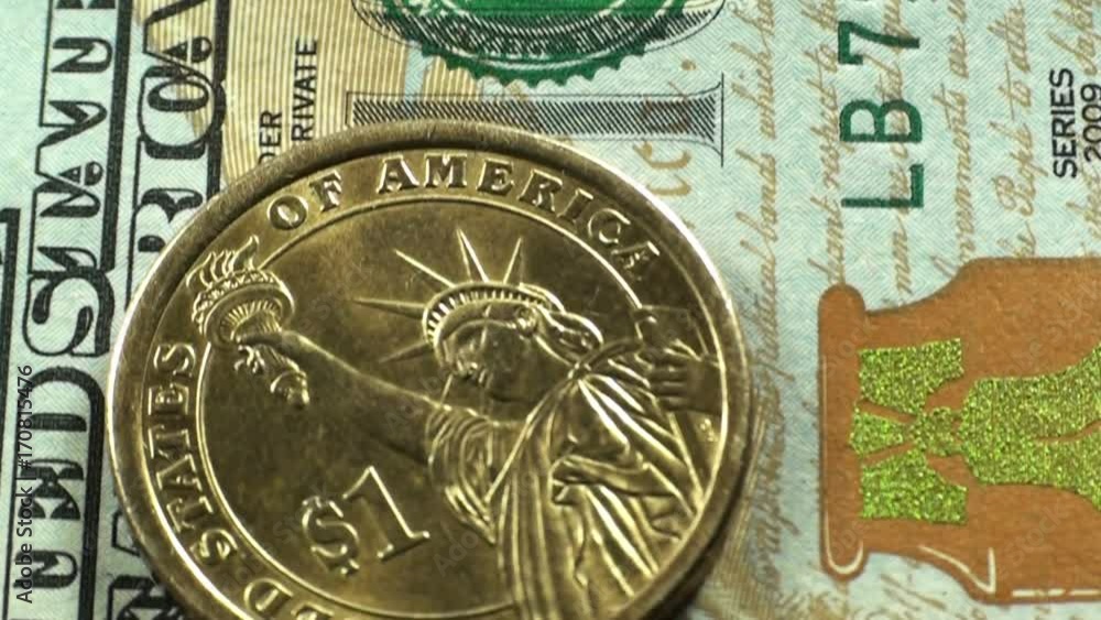 Macro view of dollar bill and coin of one dollar. Camera movement on a ...