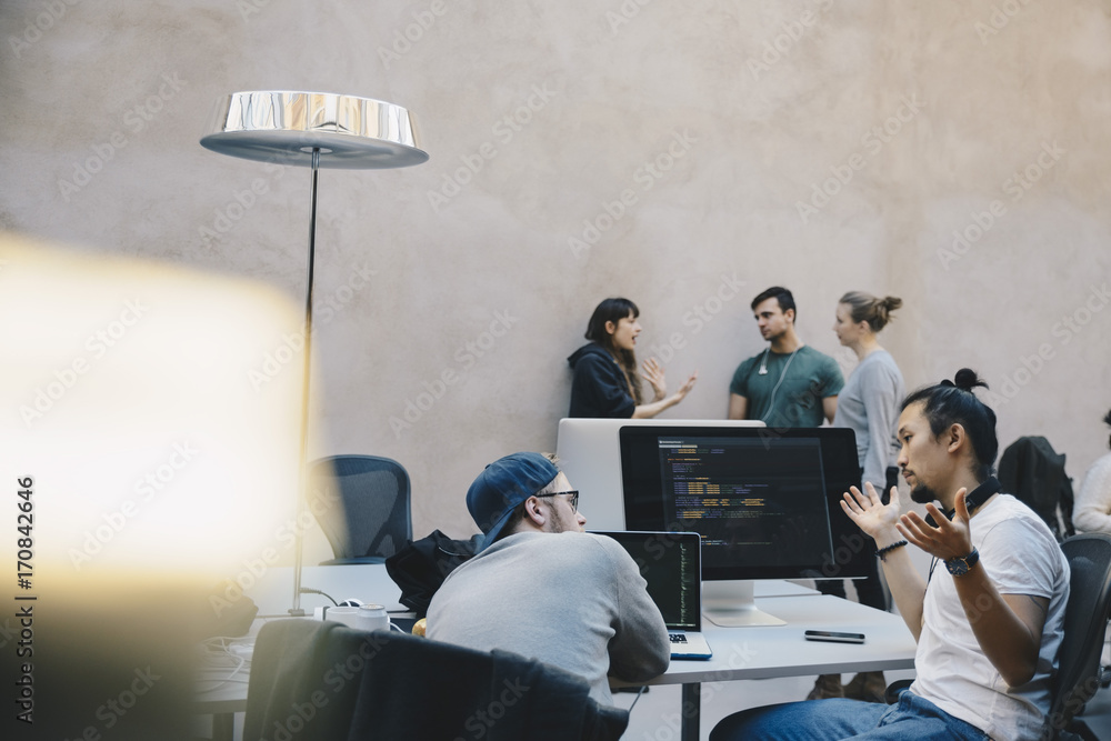 Computer programmers discussing plan in creative office Stock Photo ...